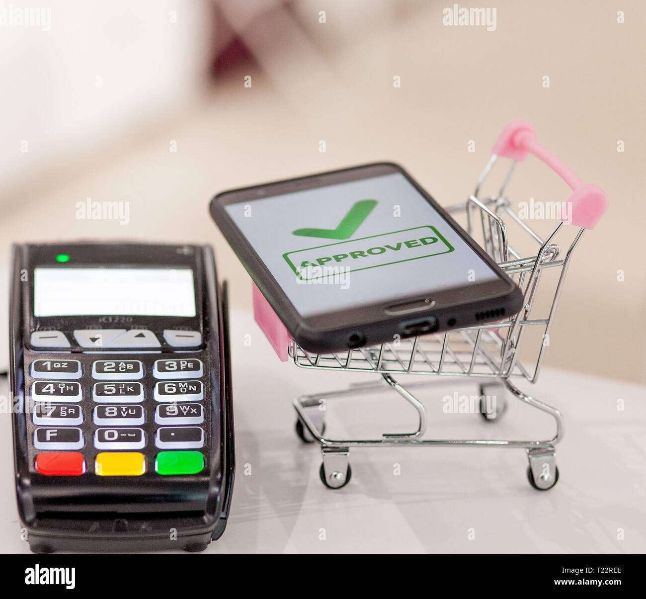 POS terminal, Payment Machine with mobile phone on store background ...