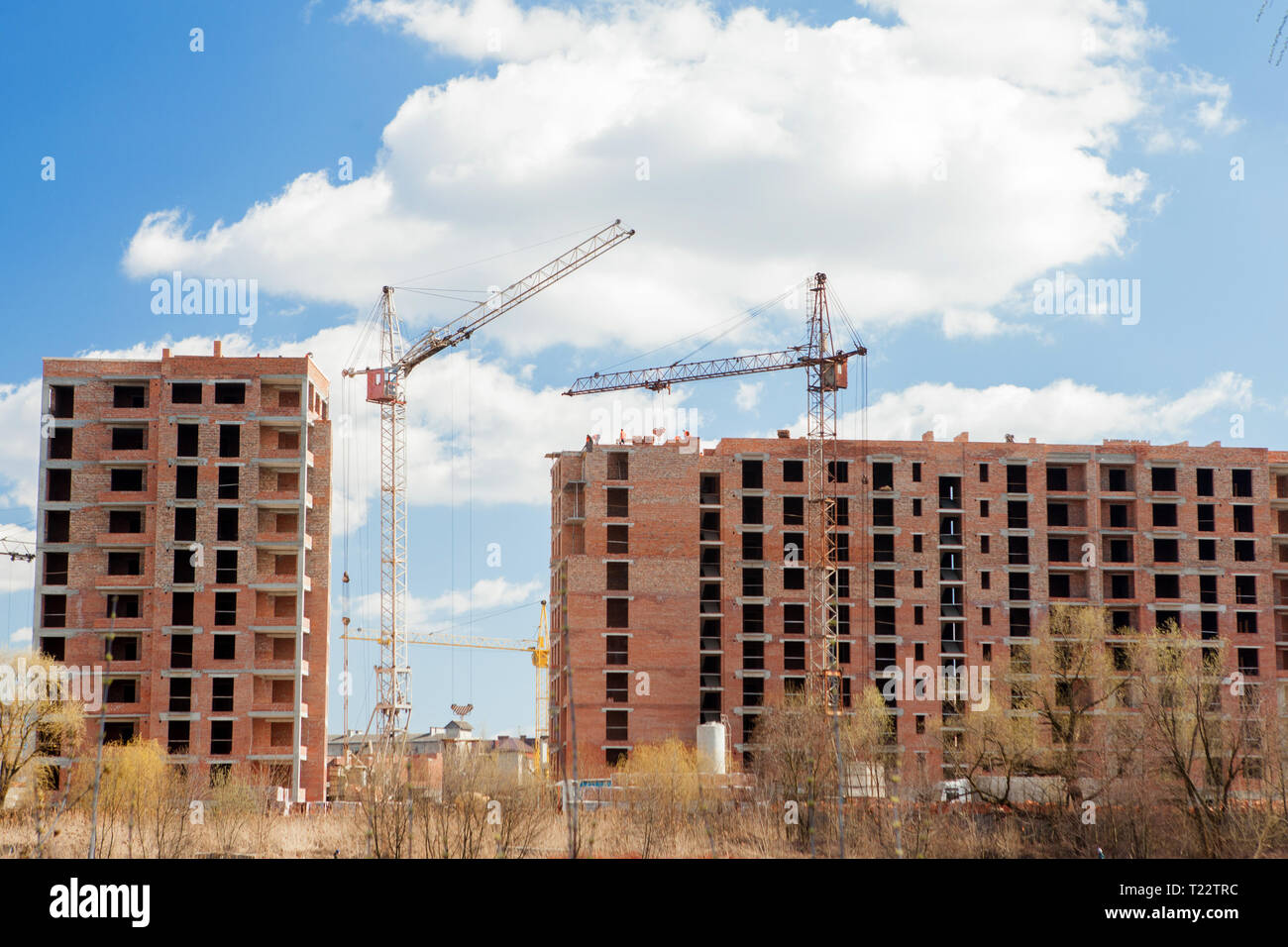 High-rise multi-storey buildings under construction. Tower cranes near ...