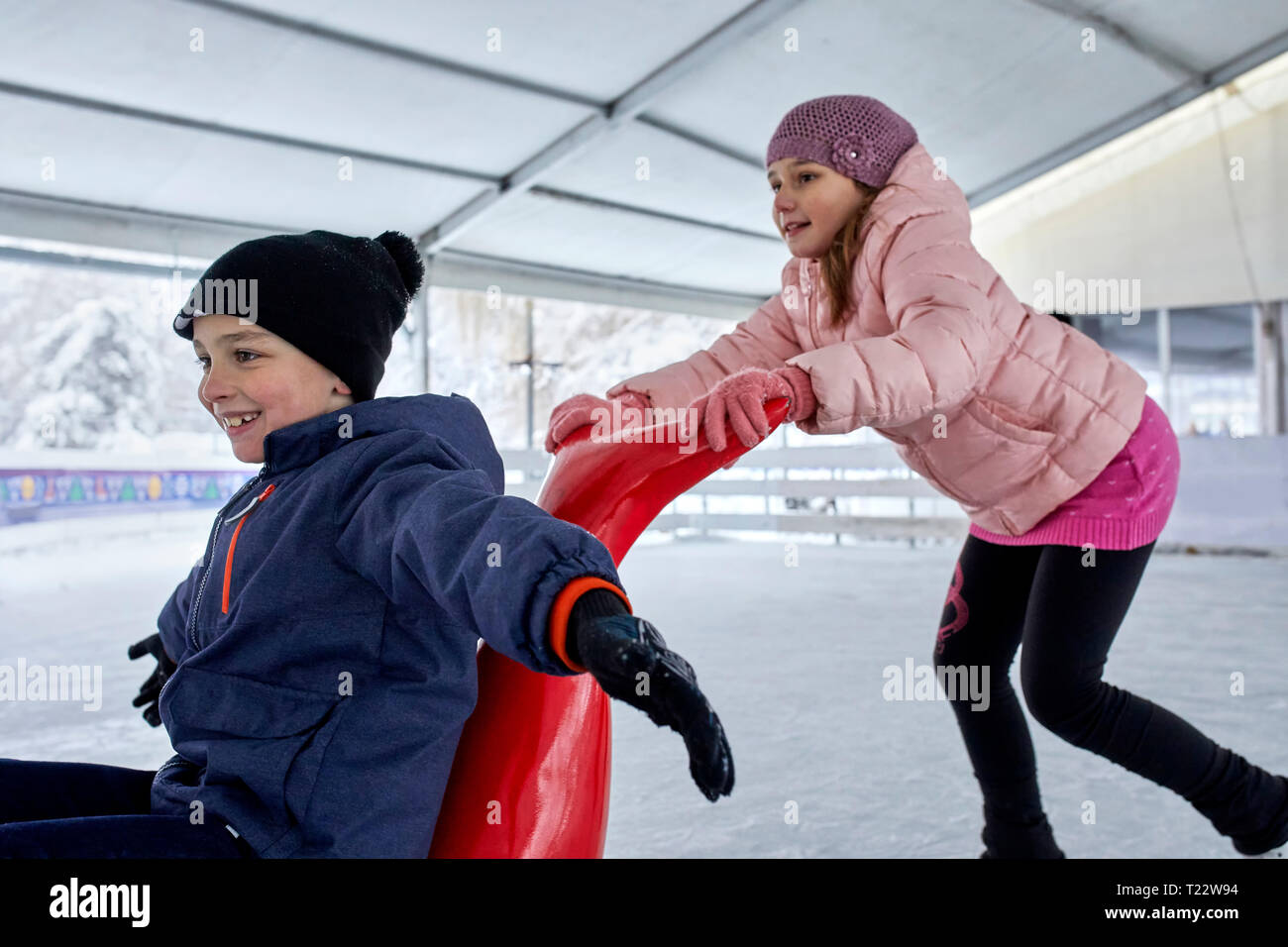 Sister pushing brother ice rink hi-res stock photography and images - Alamy