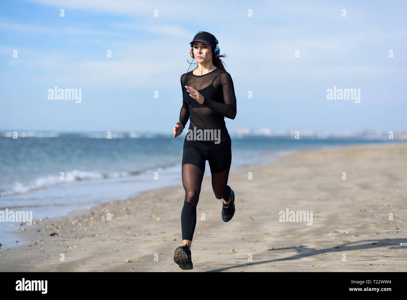Woman running beach hi-res stock photography and images - Alamy