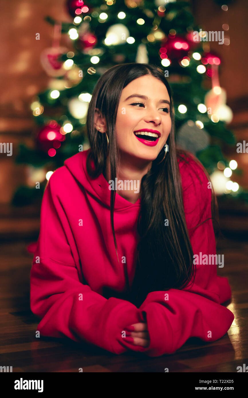 Portrait of laughing teenage girl lying on the floor in front of ... Portrait of laughing teenage girl lying on the floor in front of ...