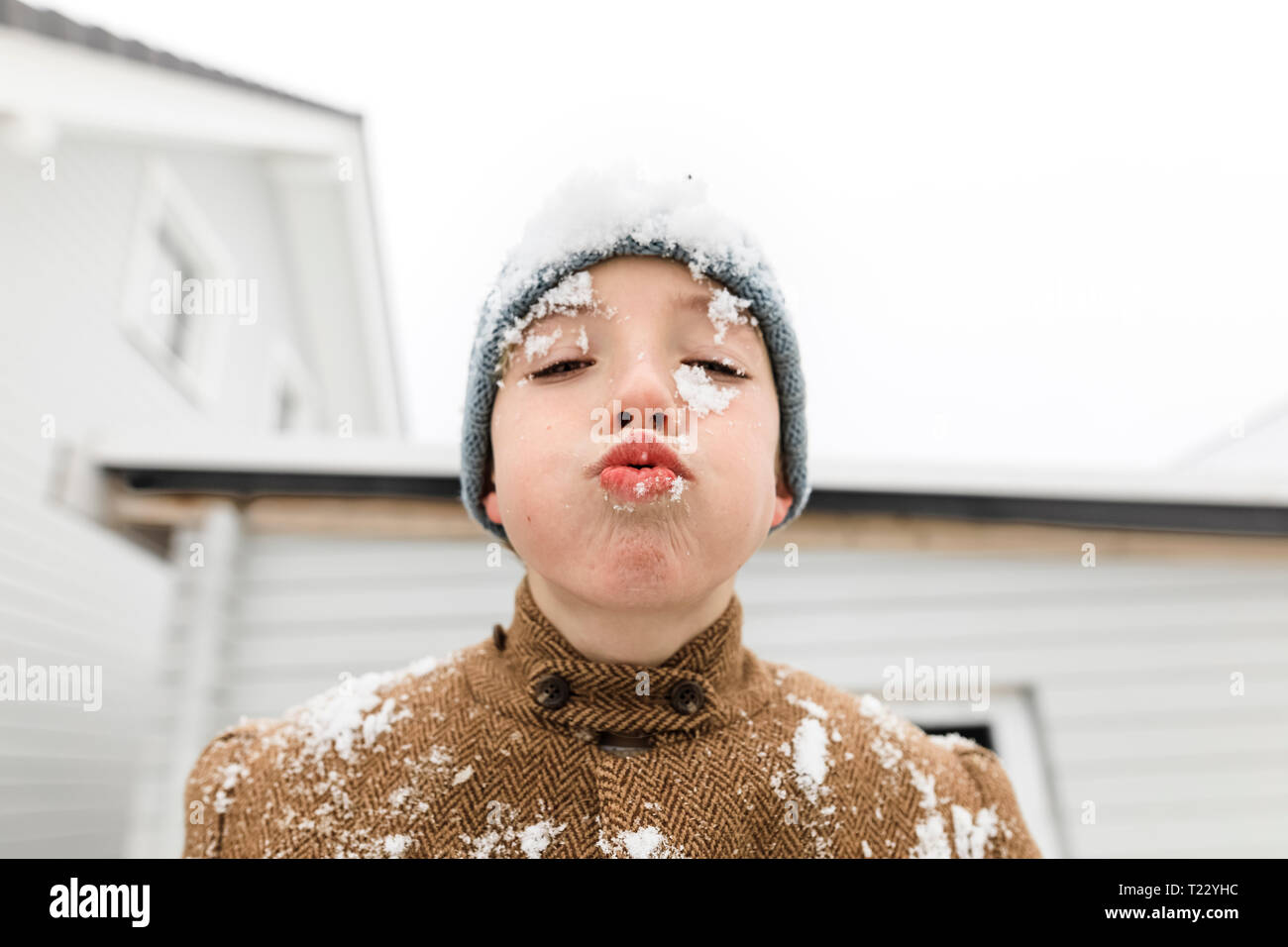 Portrait of boy with snow in his face Stock Photo - Alamy