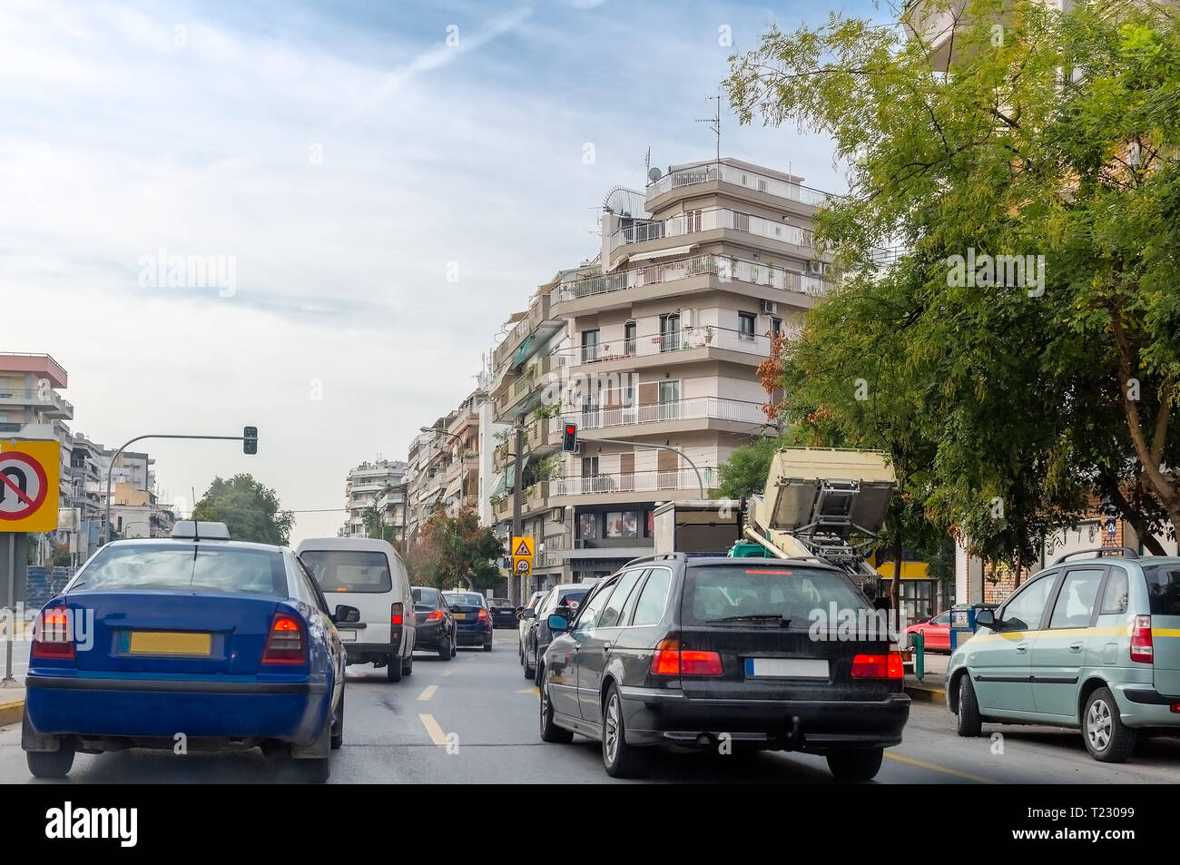 View of city. Cars on the street. On sides of street are high-rise ...