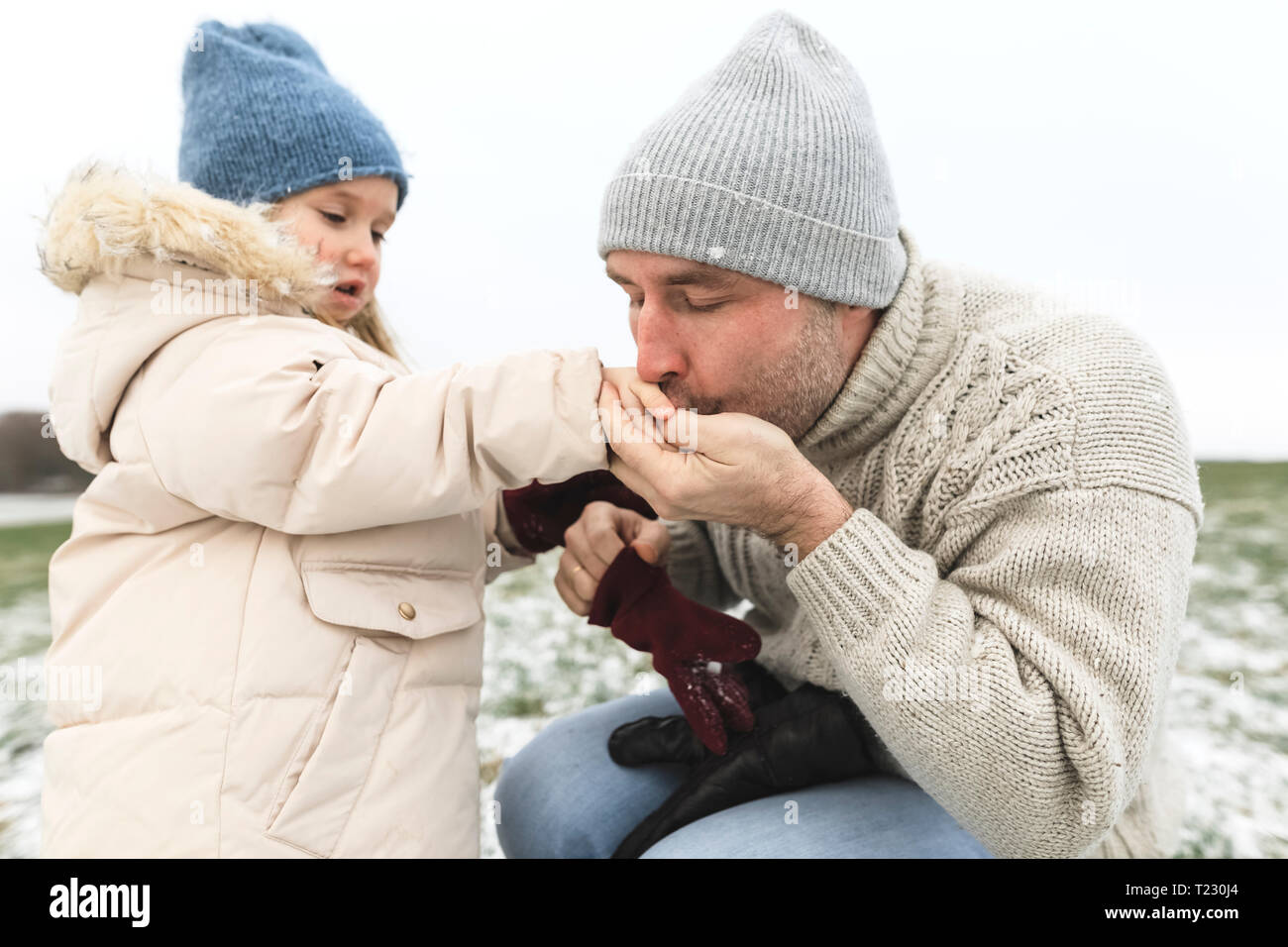 Father warming cold hands of daughter in winter Stock Photo - Alamy
