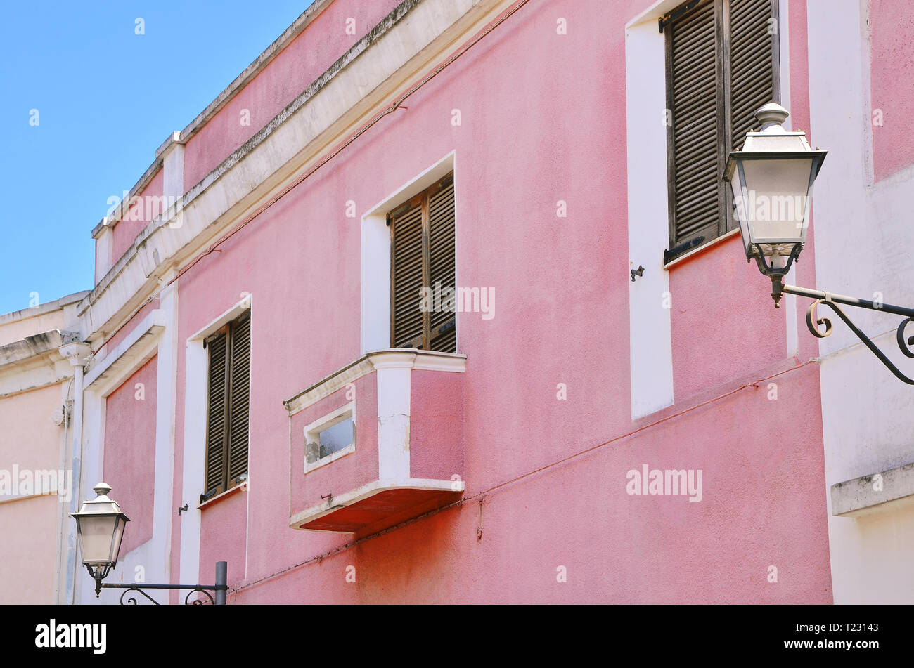 pink facade, pink house with smal balcony Stock Photo - Alamy