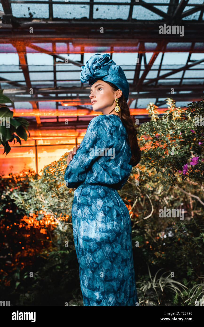 Gorgeous young woman in blue dress in turban in orangery Stock Photo ...