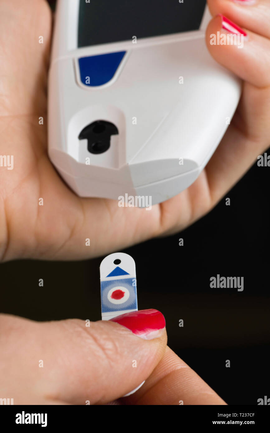 Hand using glucometer test hi-res stock photography and images - Alamy
