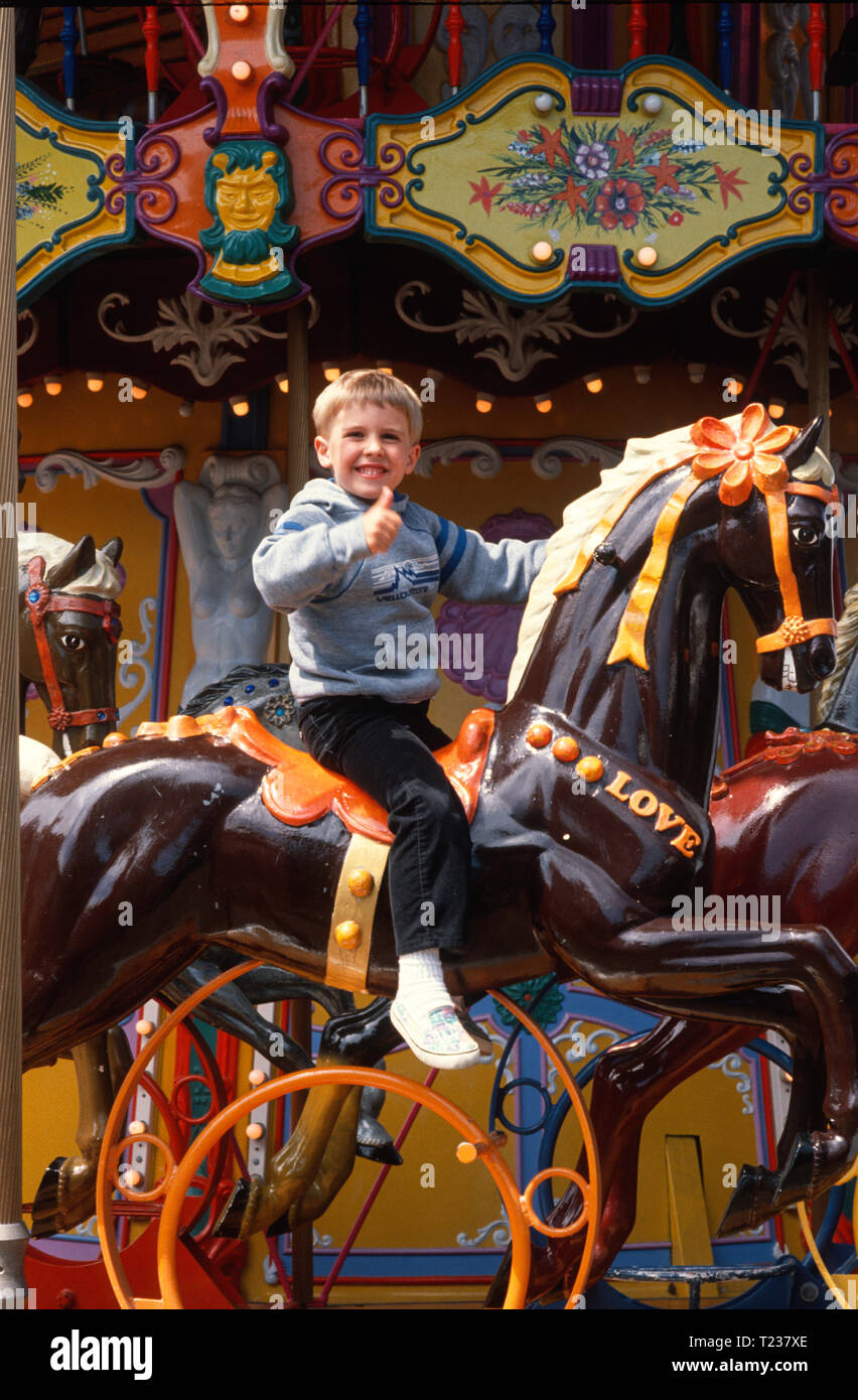 Young boy enjoying a carousel ride, USA Stock Photo - Alamy