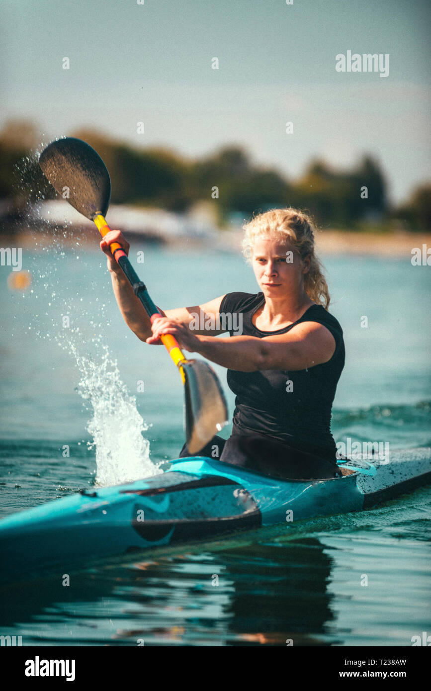 Female kayaker training on lake Stock Photo - Alamy