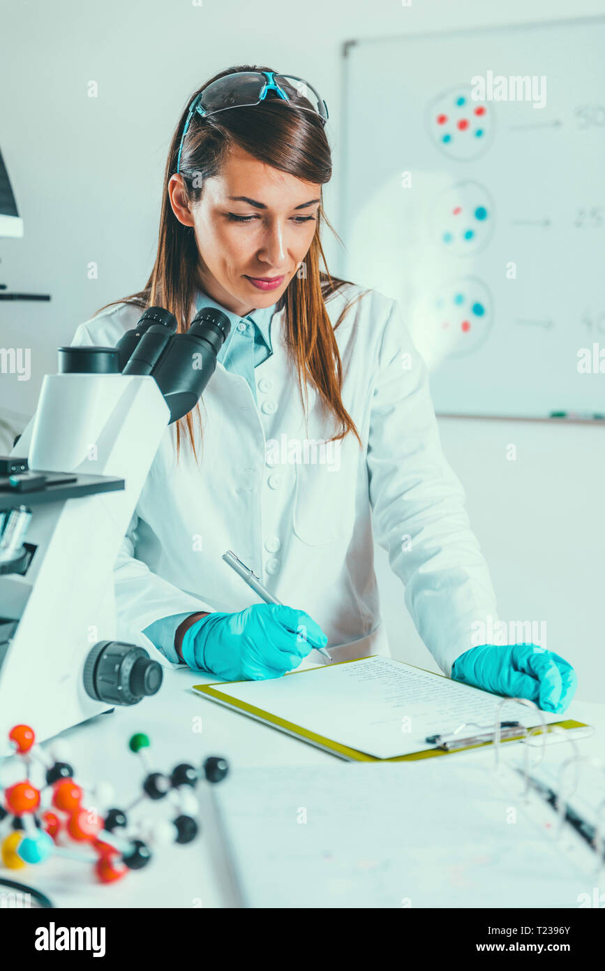 Life sciences, researcher taking observation notes Stock Photo - Alamy