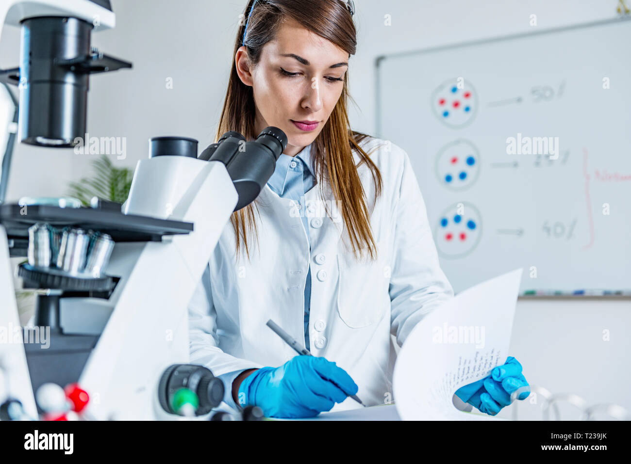 Life sciences, researcher taking observation notes Stock Photo - Alamy