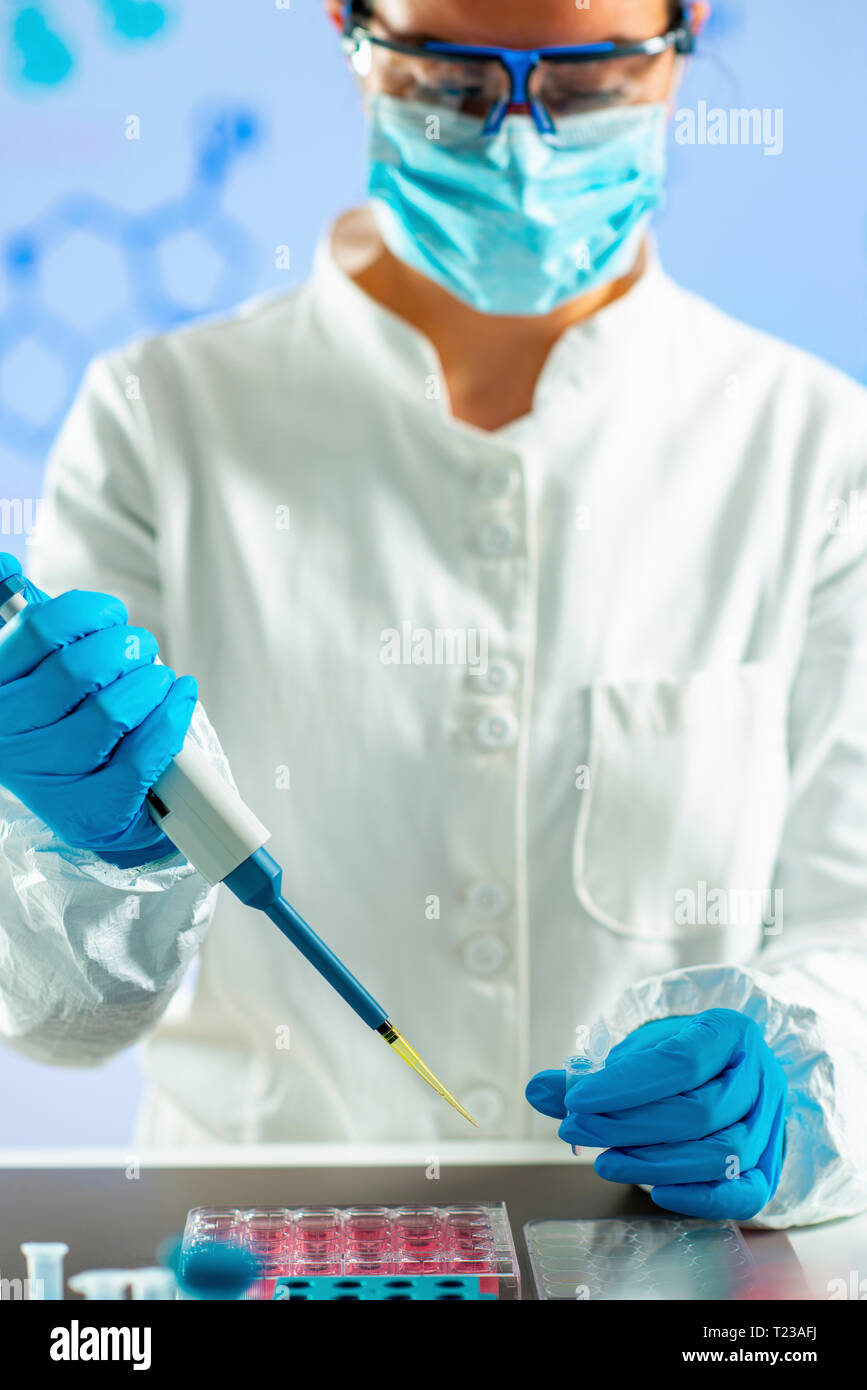 Life science research. Technician using micropipette Stock Photo - Alamy