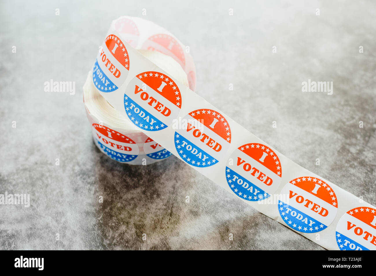 Roll of "I voted" circular stickers on a gray background for the ...