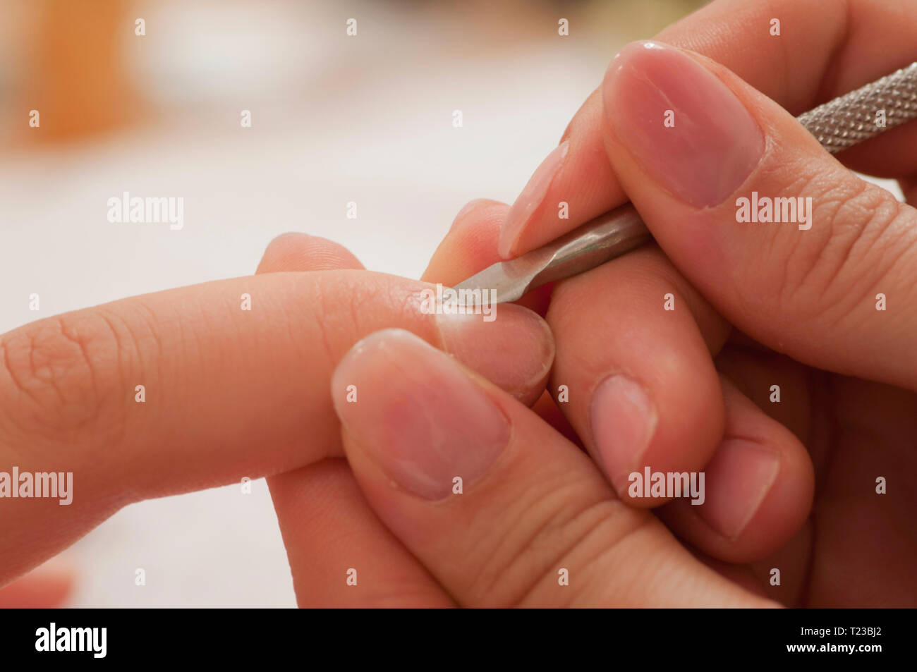 Using cuticle remover at the nail salon Stock Photo - Alamy