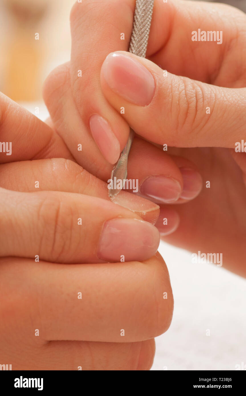 Removing excess cuticles at the nail salon Stock Photo - Alamy