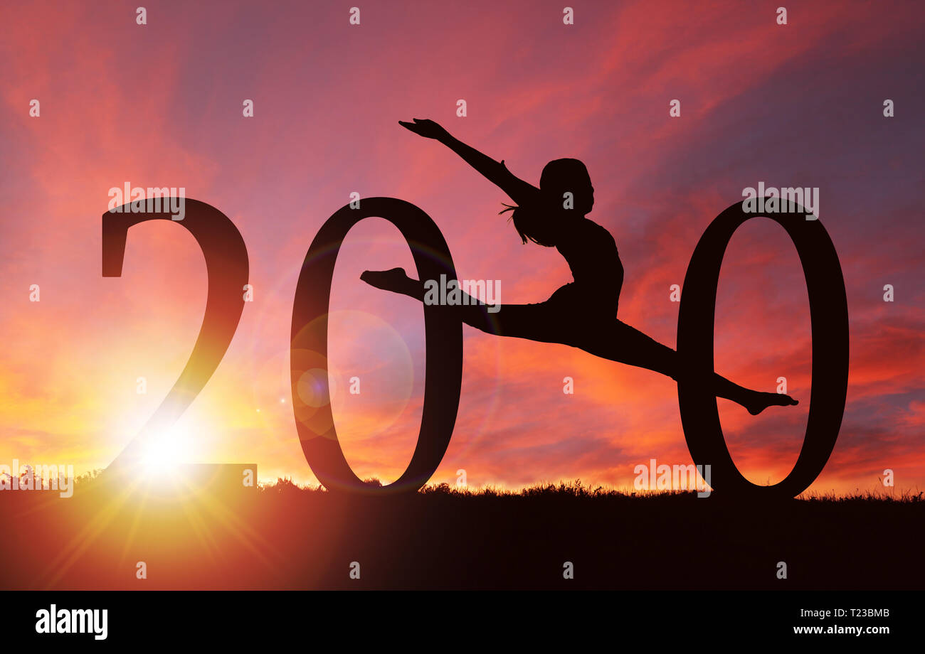 2020 New Year silhouette of a girl dancing during golden sunrise or ...