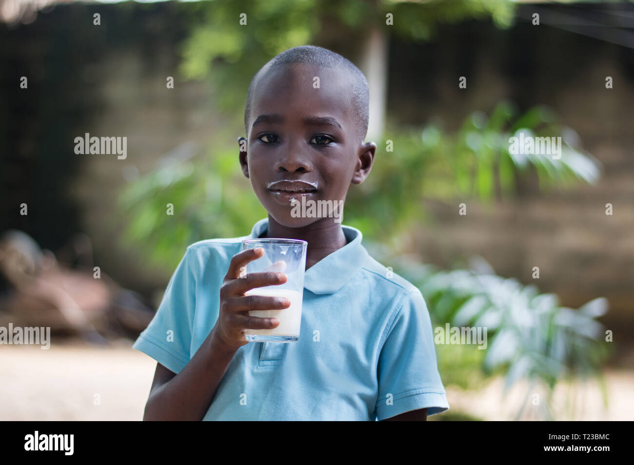 Child enjoying the taste of milk in the glass Stock Photo - Alamy