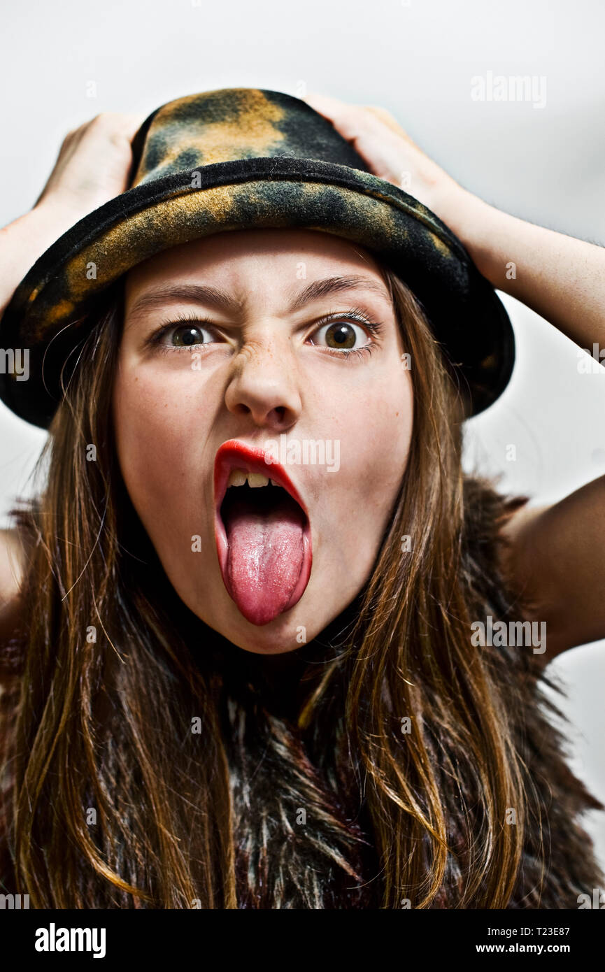 Portrait of girl sticking out tongue Stock Photo - Alamy