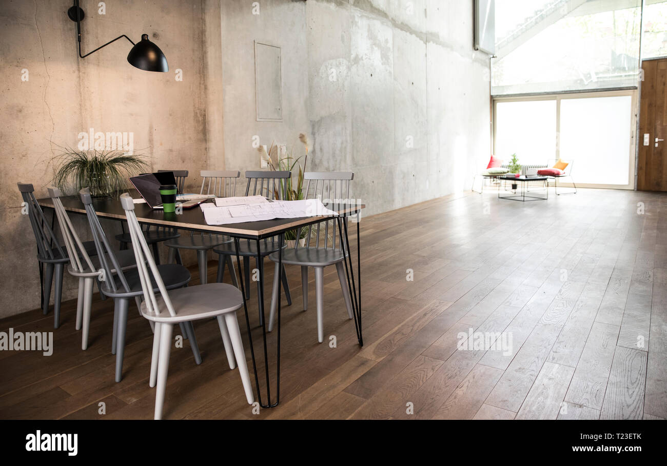 Sitting area in a loft at concrete wall Stock Photo - Alamy