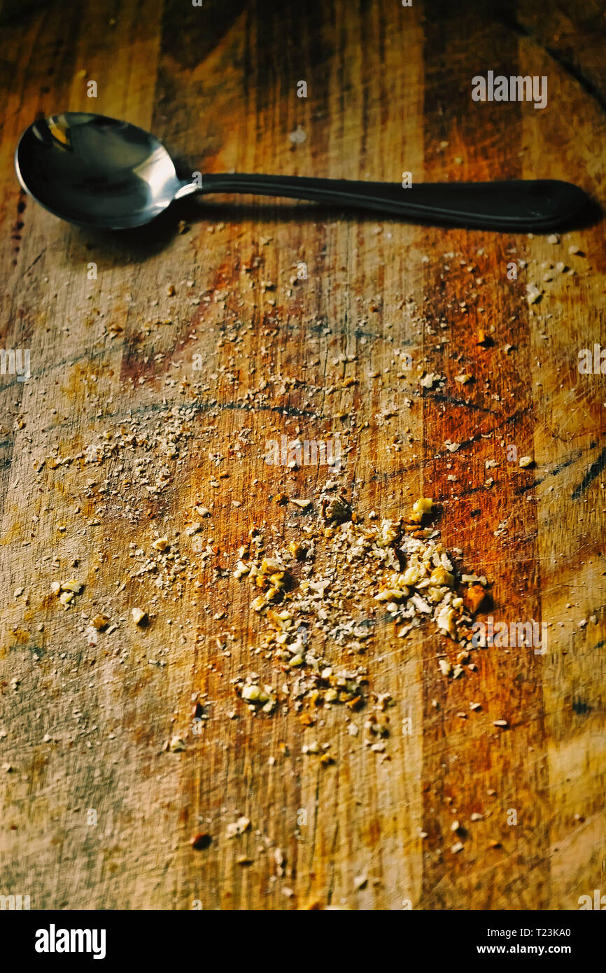 spoon on a chopping board with crumbs Stock Photo - Alamy