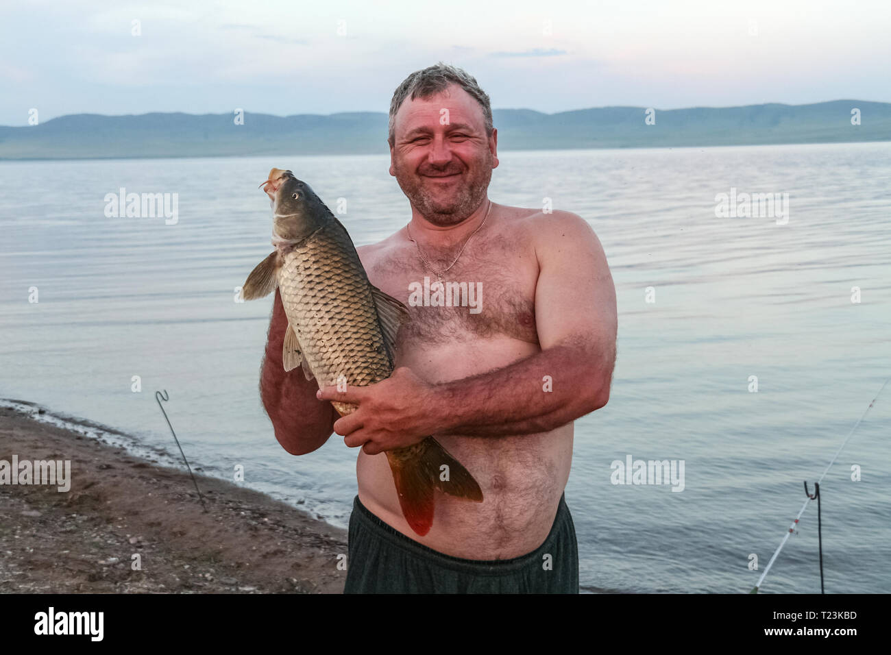 Stocky man with fish. Khakassia, Russia Stock Photo - Alamy