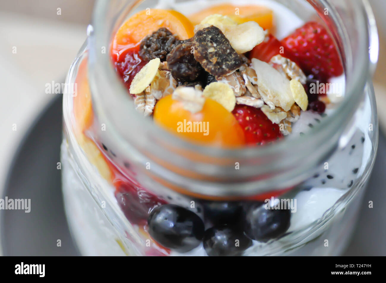 natural yogurt with fruit and granola topping Stock Photo - Alamy
