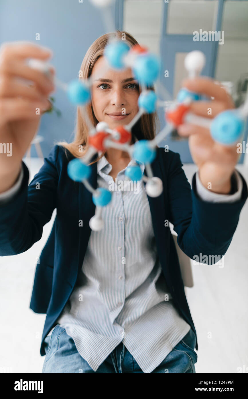 Female scientist studying molecule model Stock Photo - Alamy
