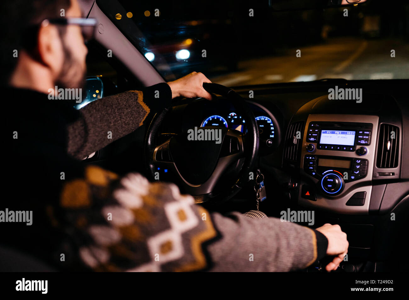 Man driving car at night Stock Photo - Alamy