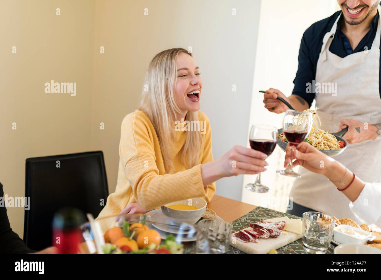 Friends having lunch together, drinking red wine Stock Photo - Alamy