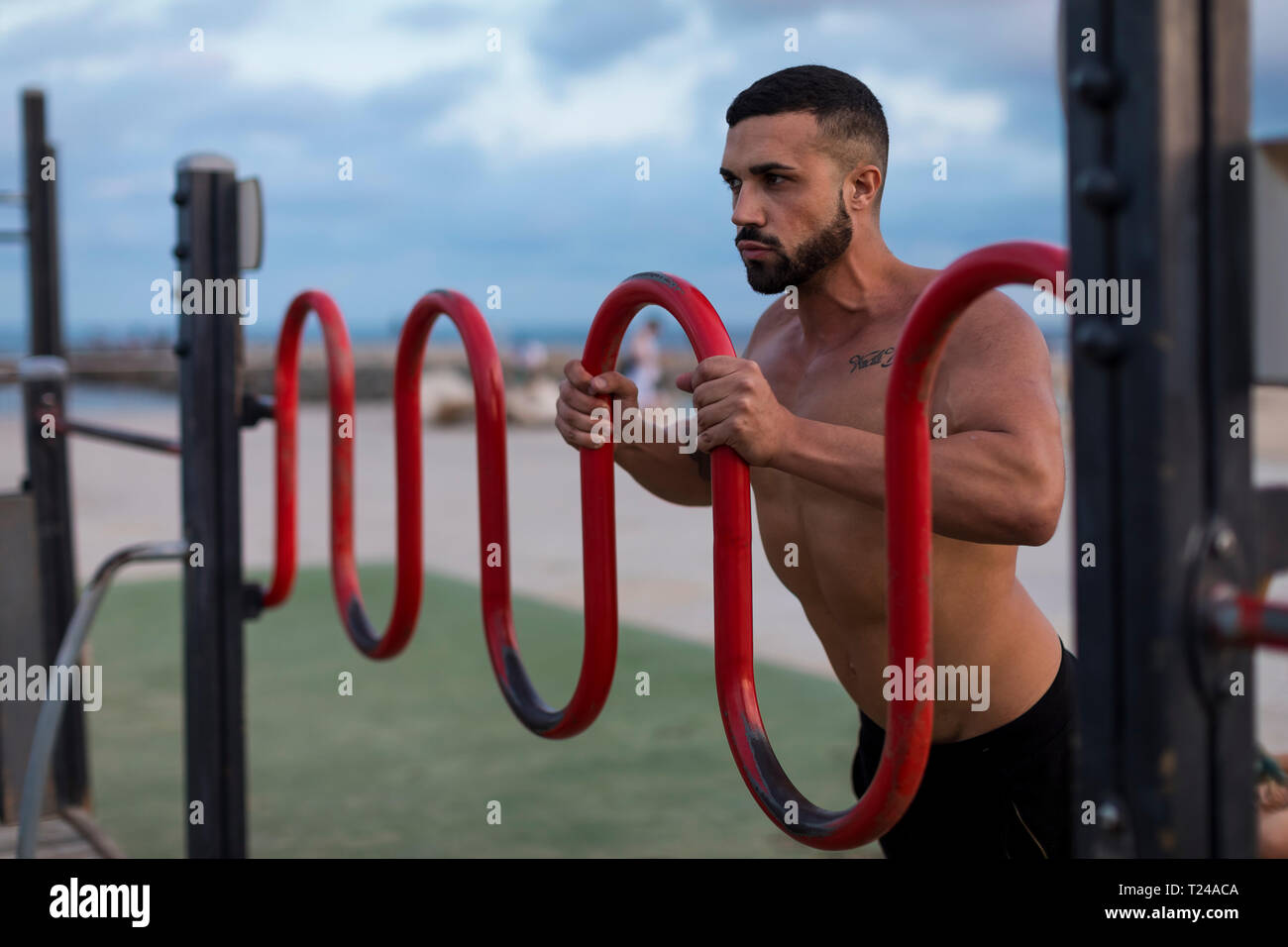Barechested muscular man doing workout outdoors Stock Photo - Alamy