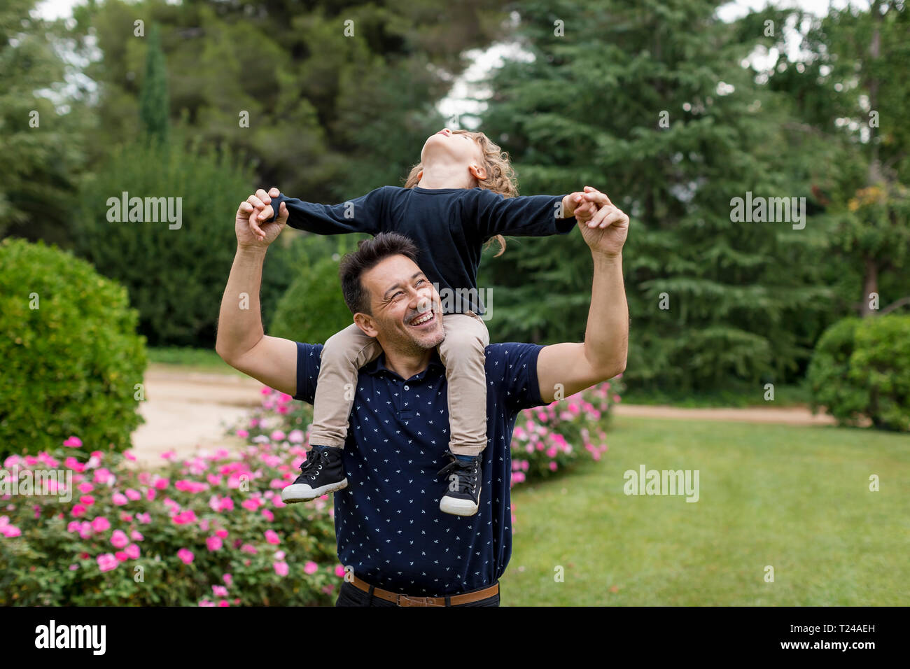 Happy father carrying son on shoulders in park Stock Photo - Alamy