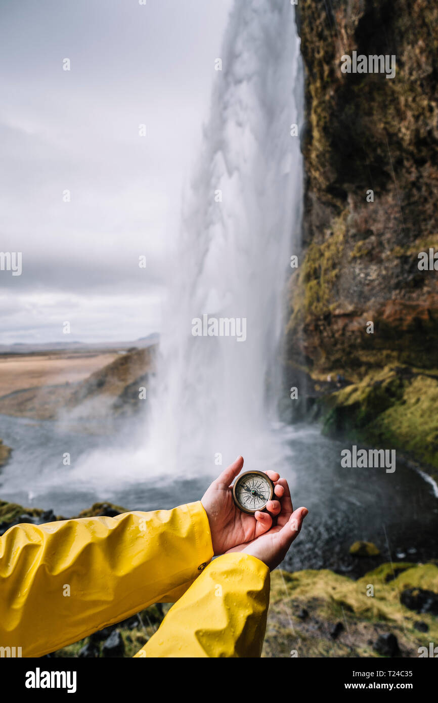 Iceland, Seljalandsfoss Waterfall, woman's hand holding compass Stock ...