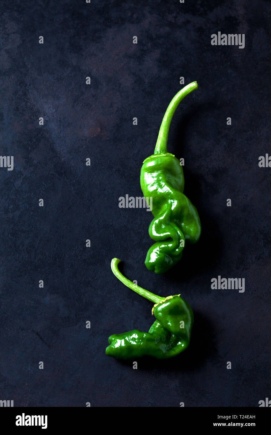 Green peperonis aon dark background Stock Photo - Alamy