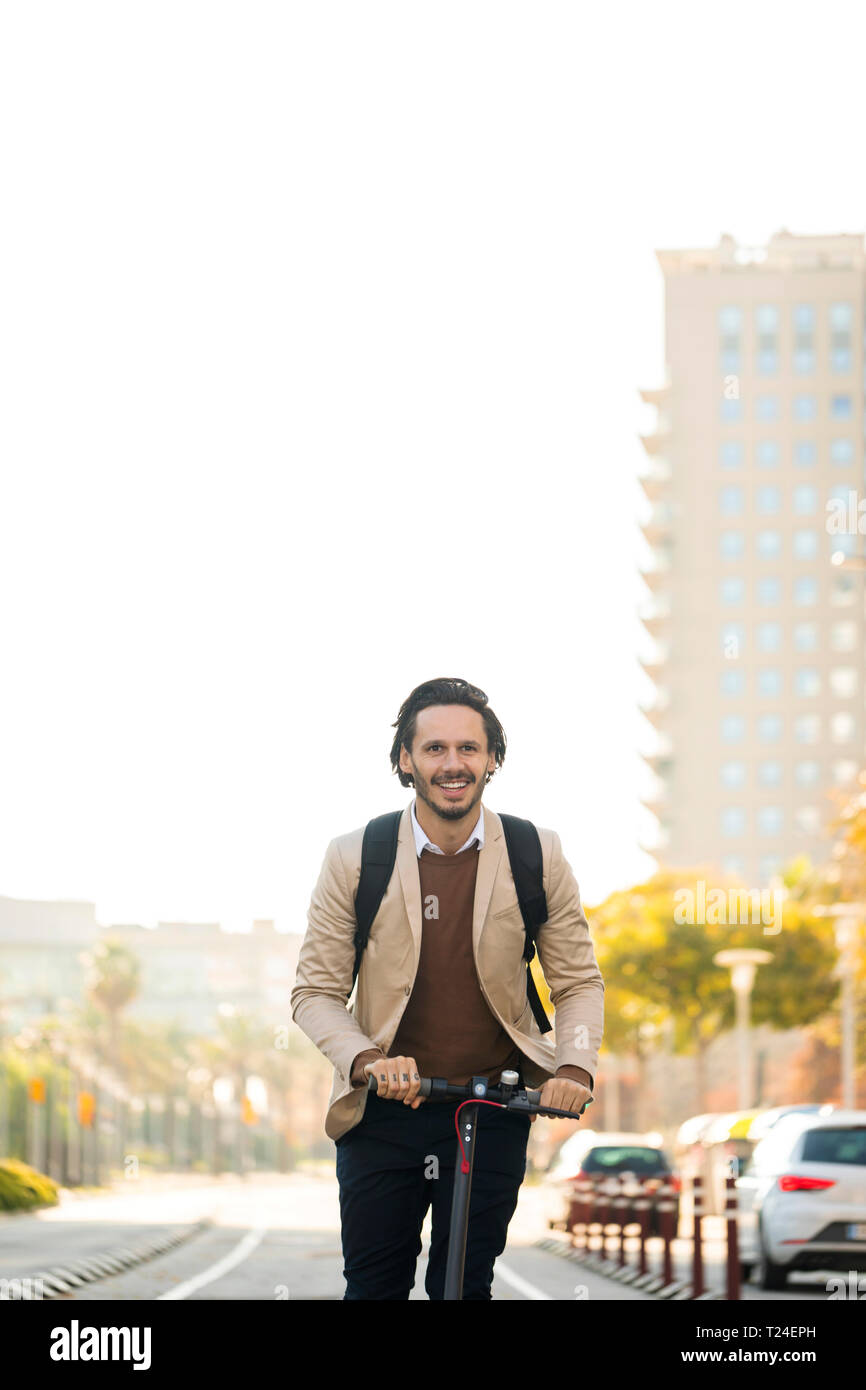 Content man with using E-Scooter in the city Stock Photo - Alamy