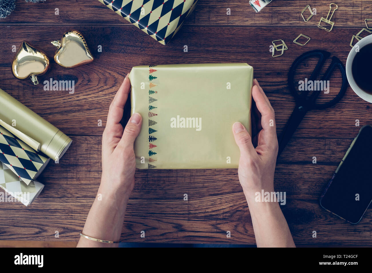Woman's hands holding wrapped Christmas present, top view Stock Photo ...