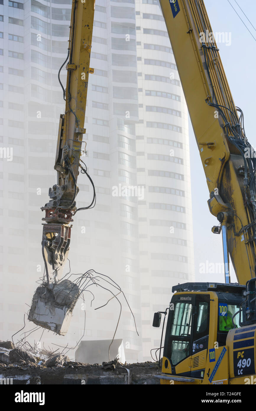 demolition of building (former cinema) with breaker, worker, highrise ...