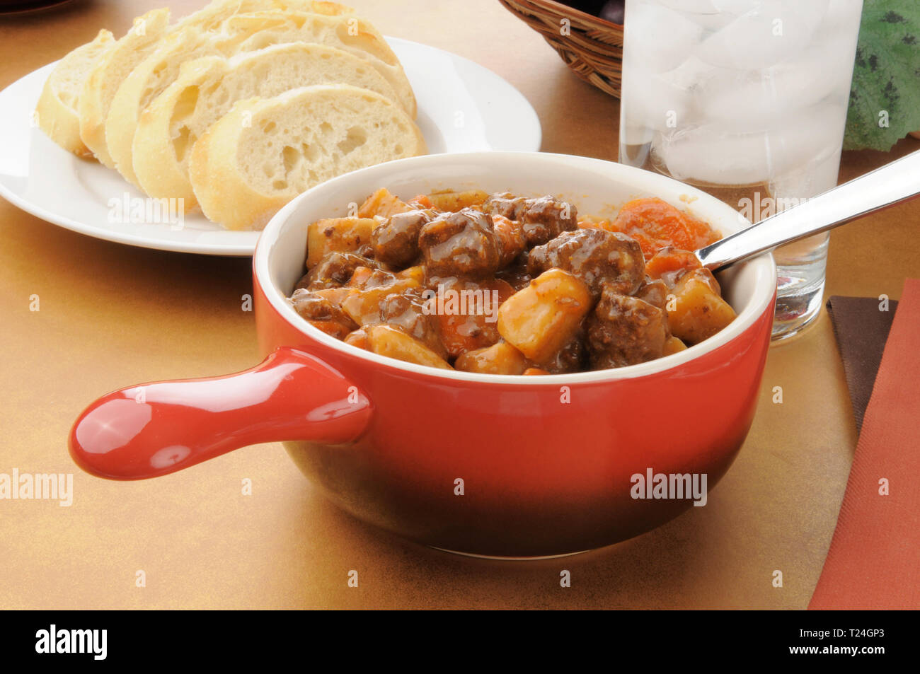 Hearty beef stew in a stoneware serving crock Stock Photo - Alamy