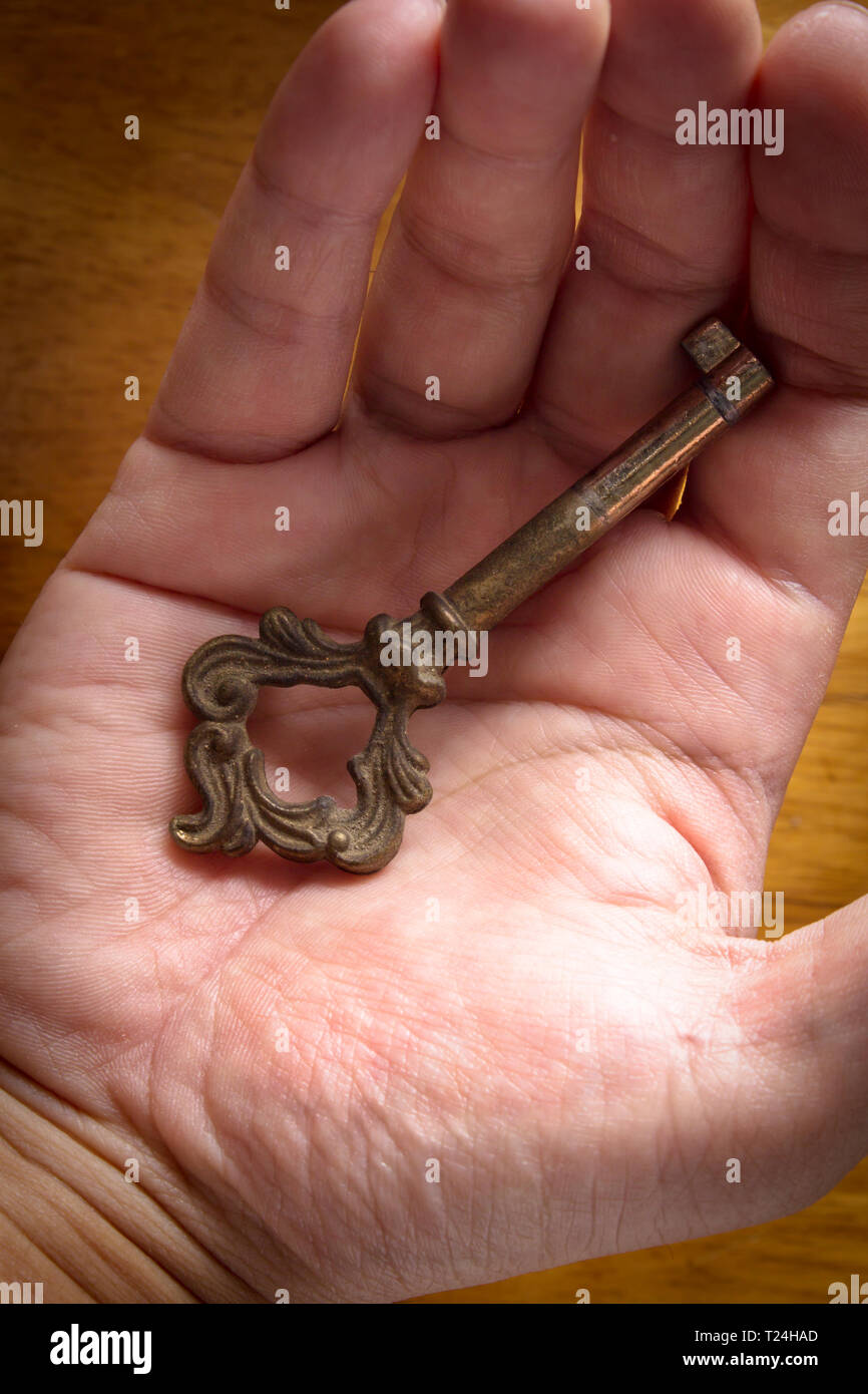 Antique key in hand,top view Stock Photo - Alamy