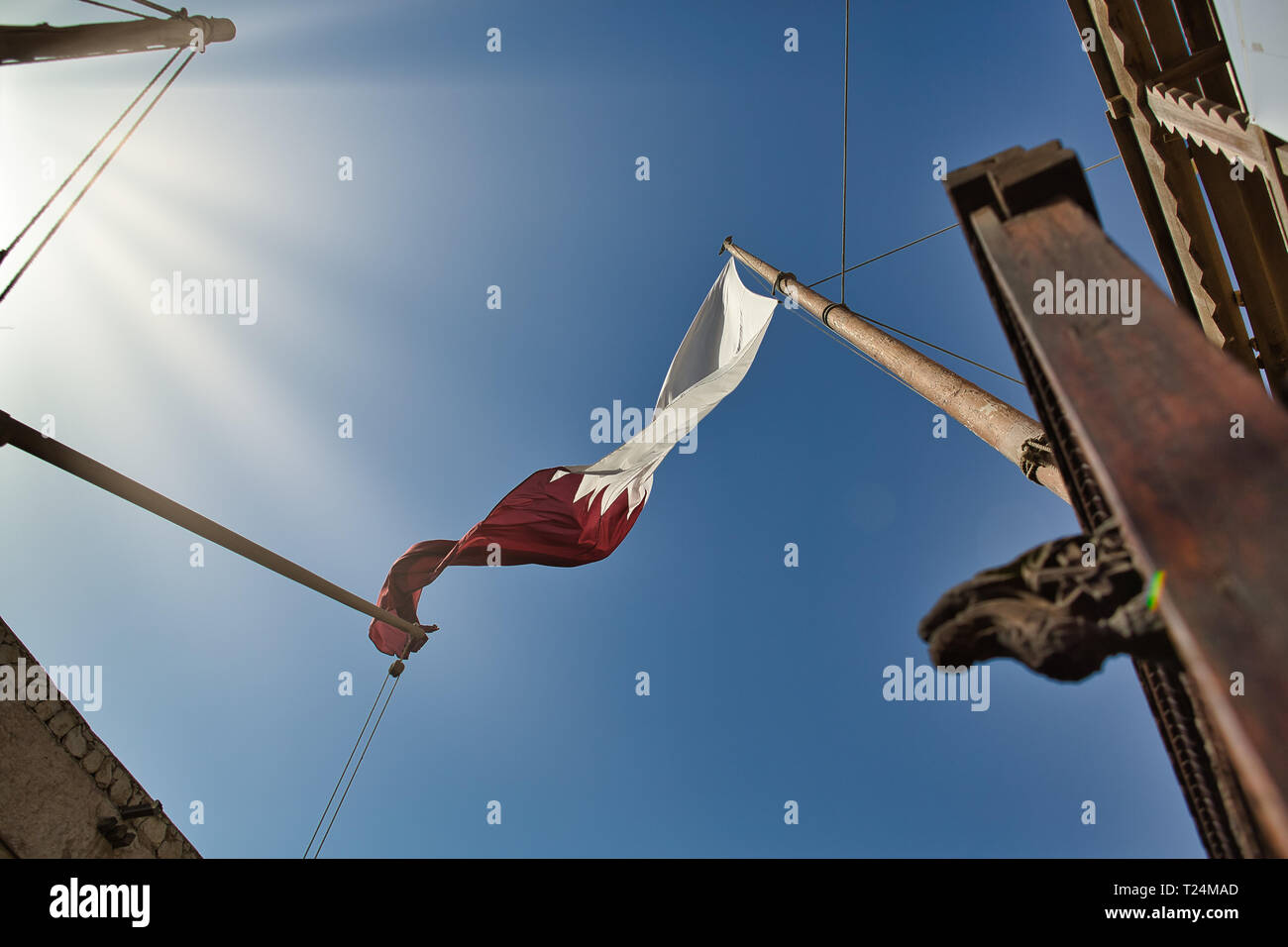 Qatar flag waving in the wind with a morning sun-rays Stock Photo - Alamy