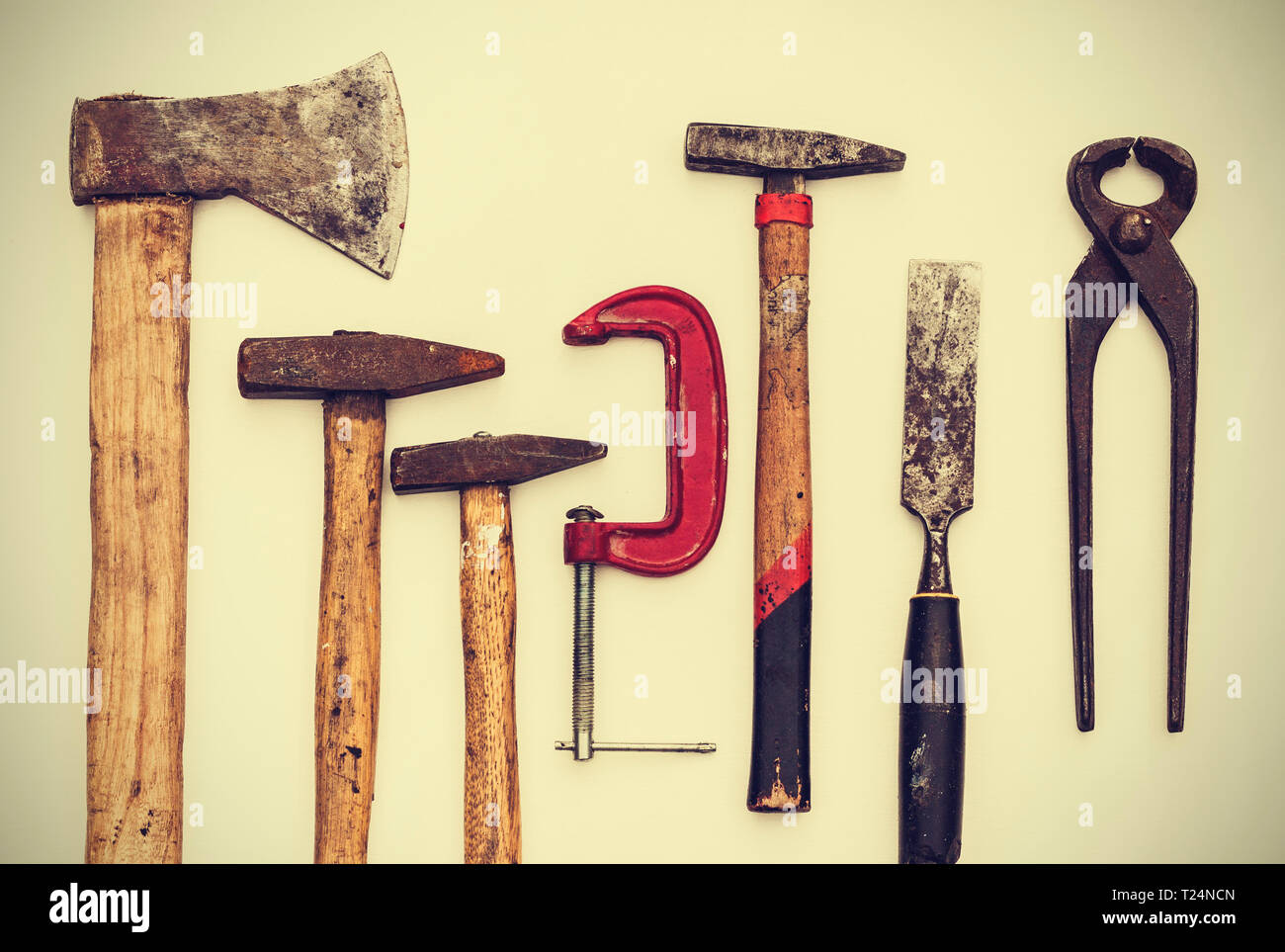 Set of vintage hand construction tools on a white wooden background ...