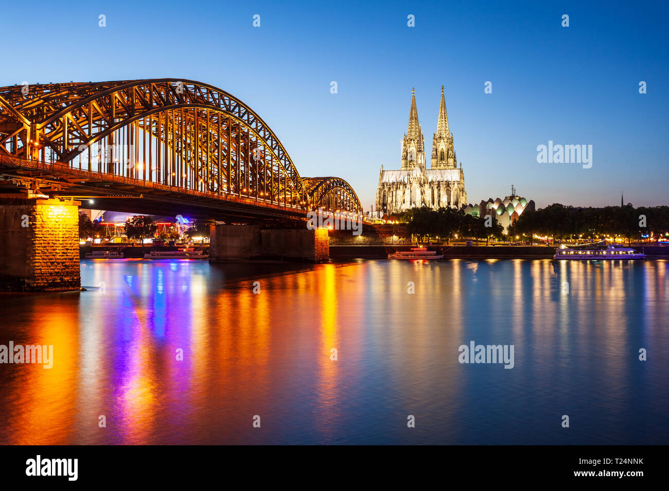 Cologne Cathedral and Hohenzollern Bridge through Rhine river in ...