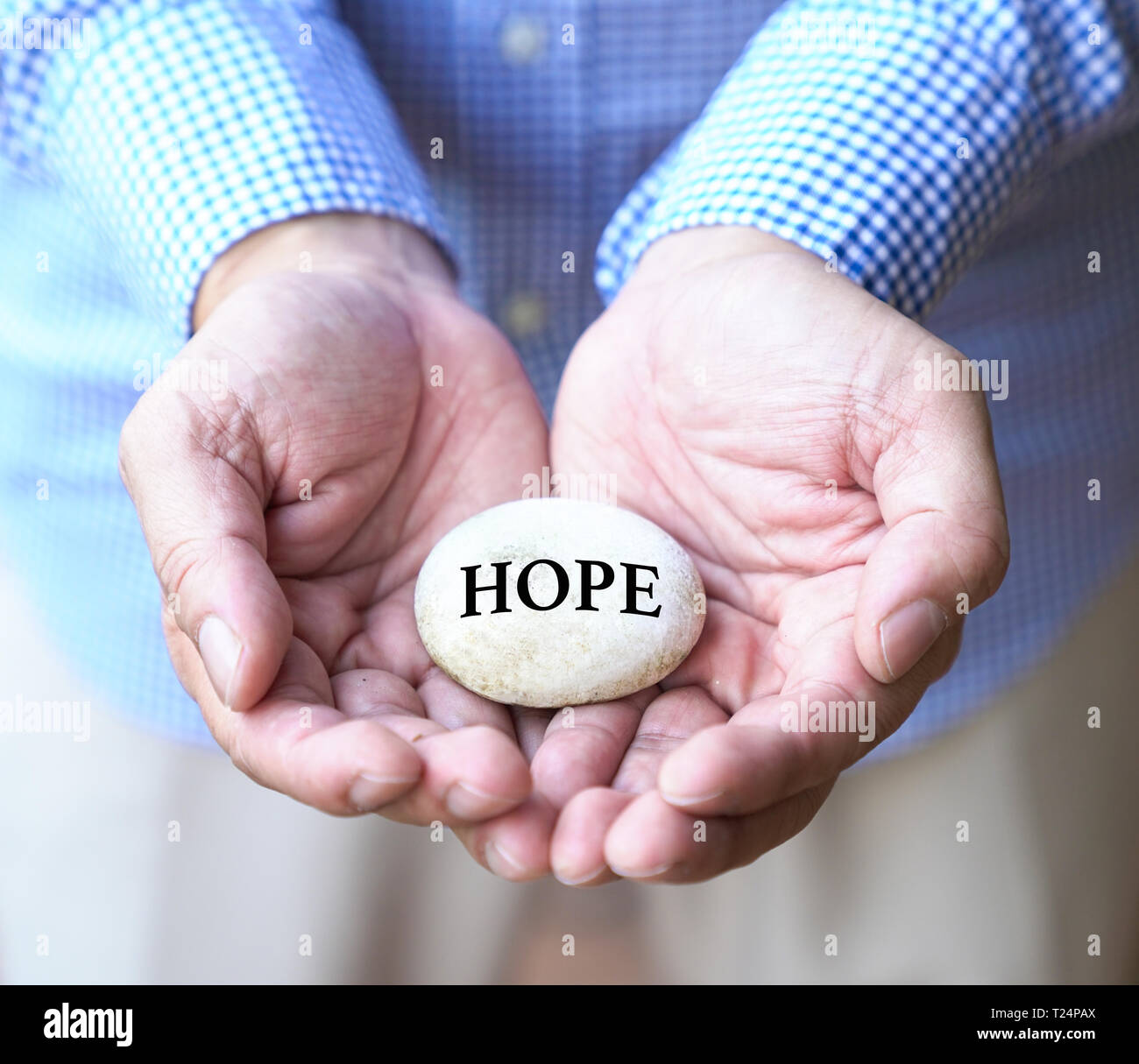 Hope concept, words on pebble cupped with both hands Stock Photo - Alamy