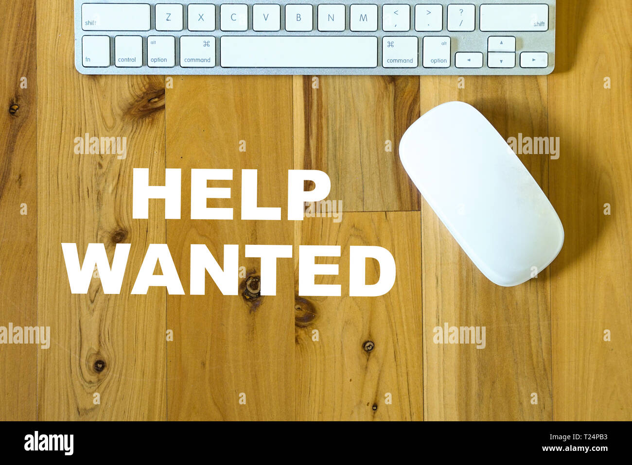 Help wanted, words printed on desktop with keyboard and mouse in view ...