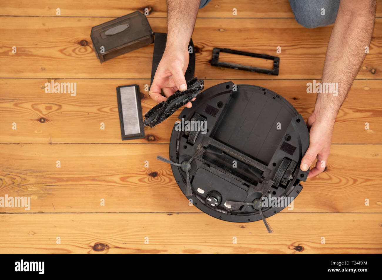 Cleaning the robot vacuum cleaner , robot vacuum cleaner service Stock ...