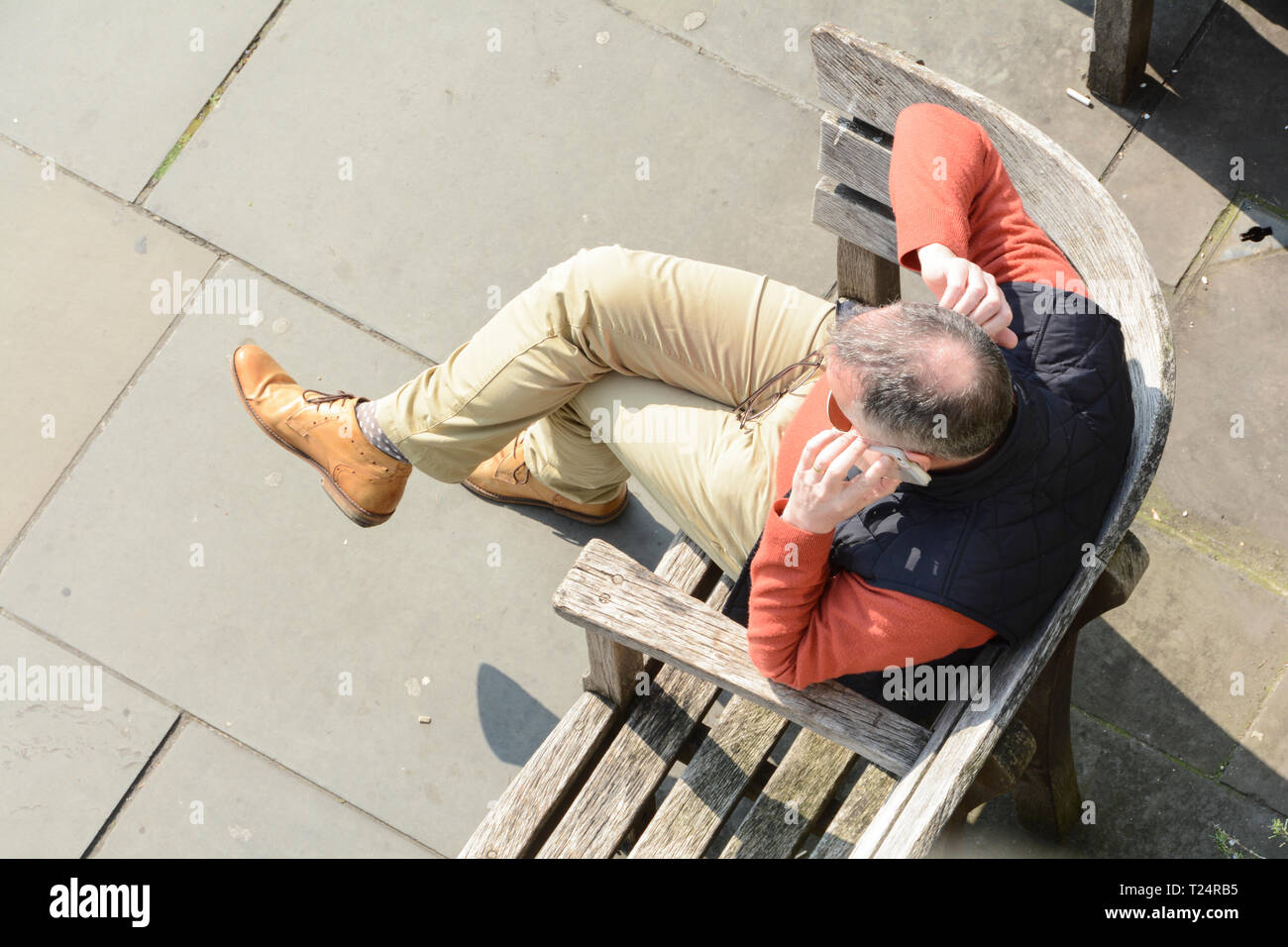A bald headed man making a call on his mobile phone in London, UK Stock ...