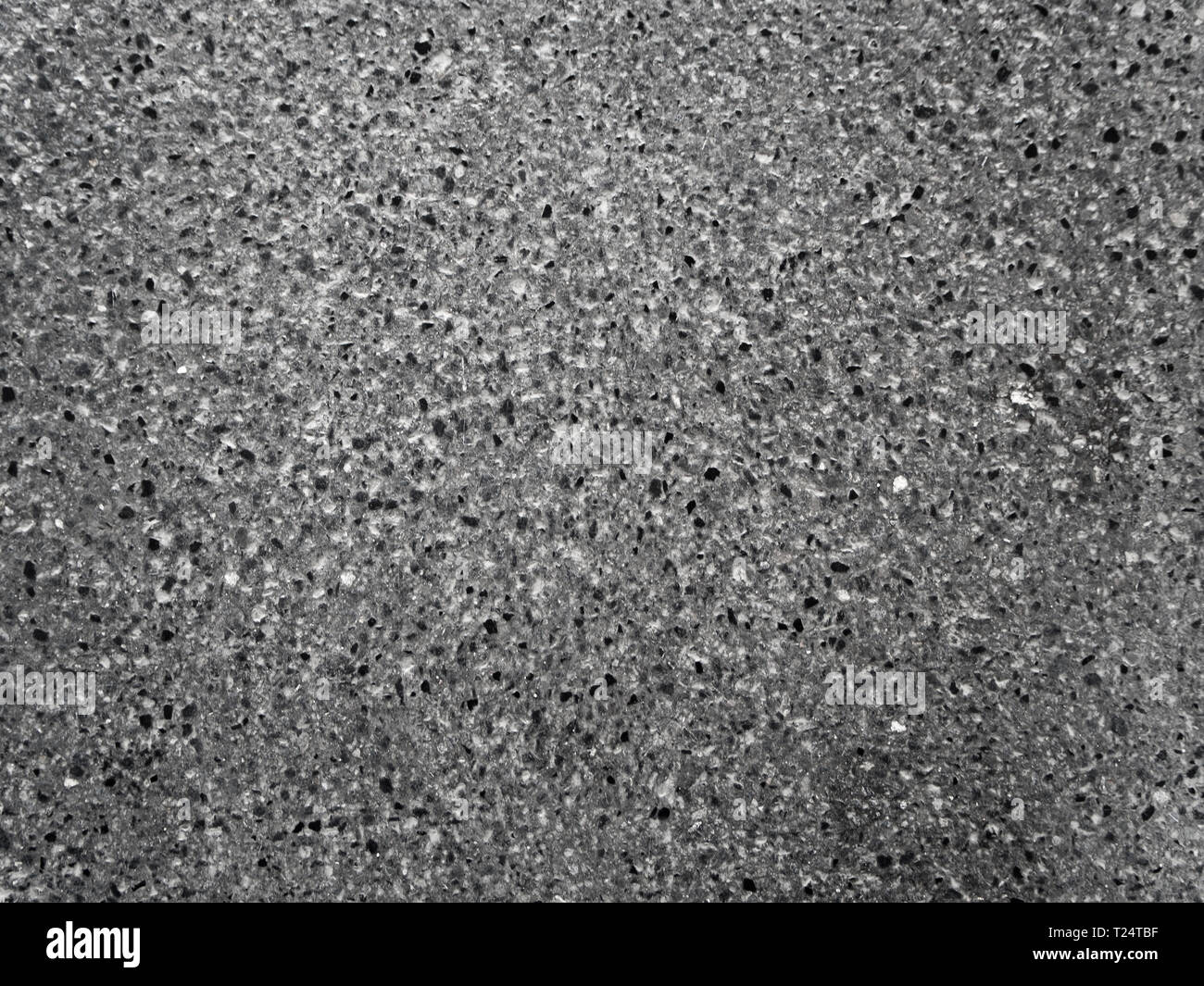 Small black rock in Rough Concrete floor Stock Photo - Alamy