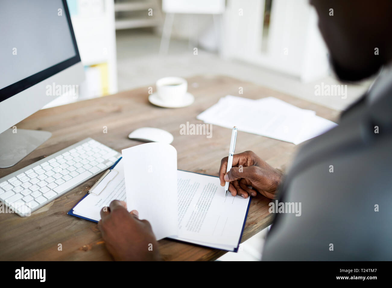 Person desk signing paperwork hi-res stock photography and images - Alamy