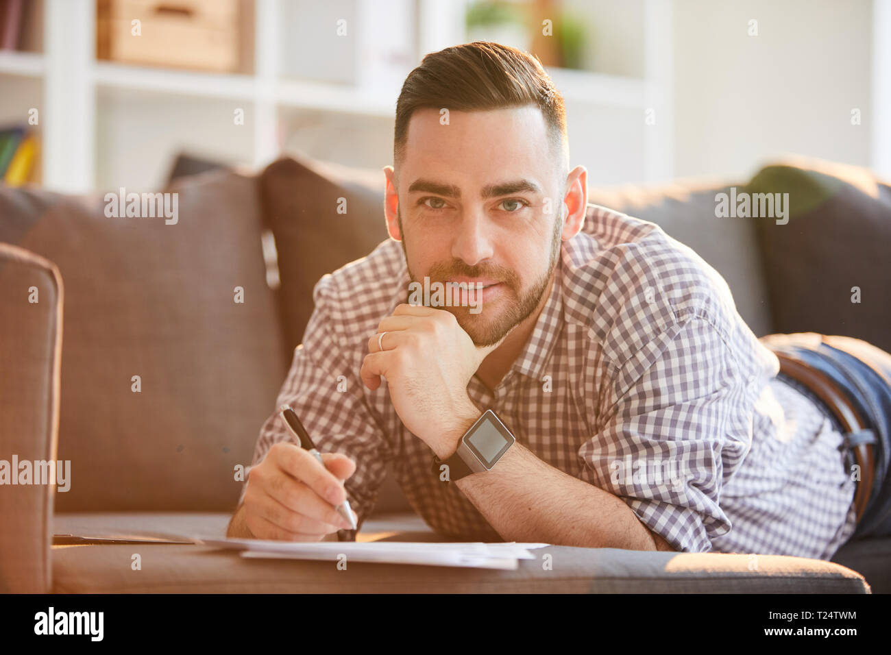 Man on sofa hi-res stock photography and images - Alamy