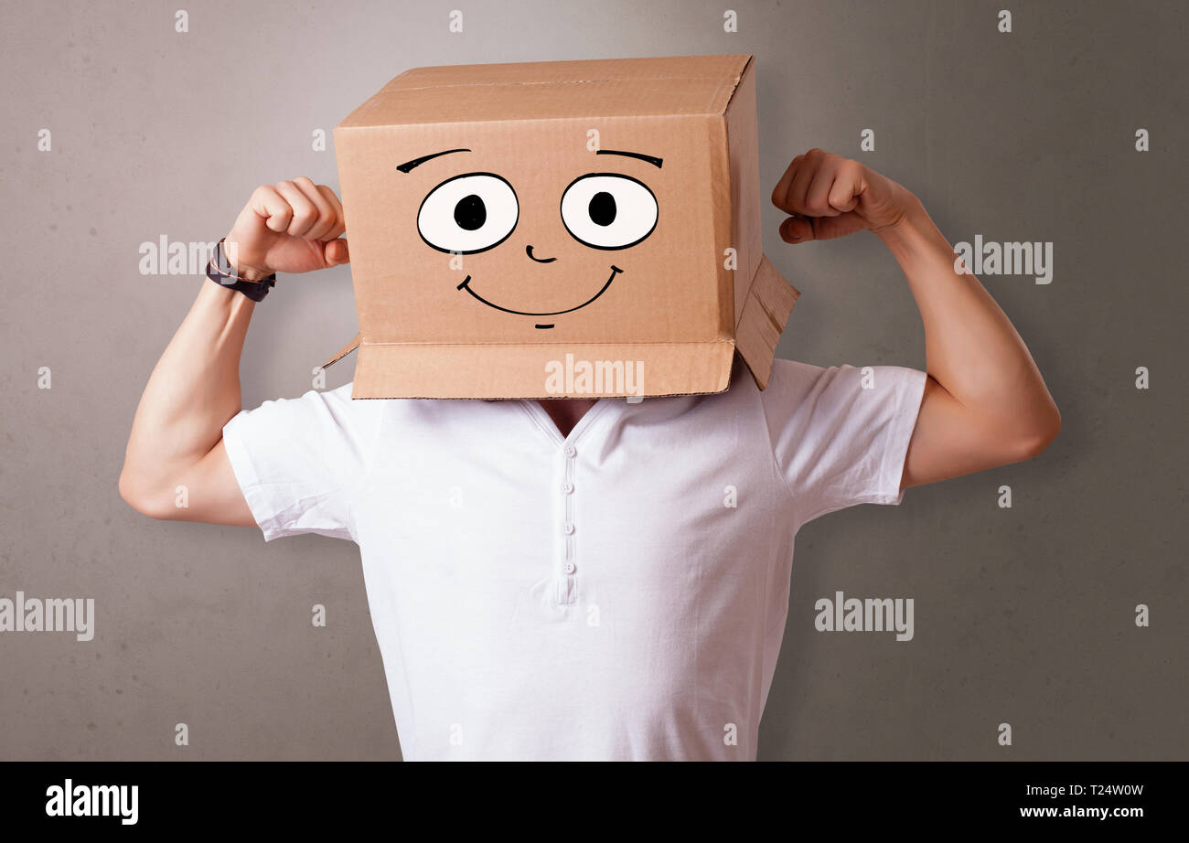 Young boy standing and gesturing with a cardboard box on his head Stock ...