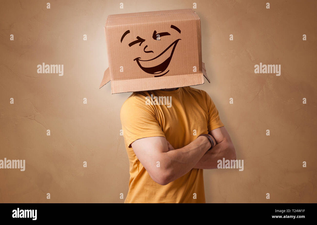 Young boy standing and gesturing with a cardboard box on his head Stock ...